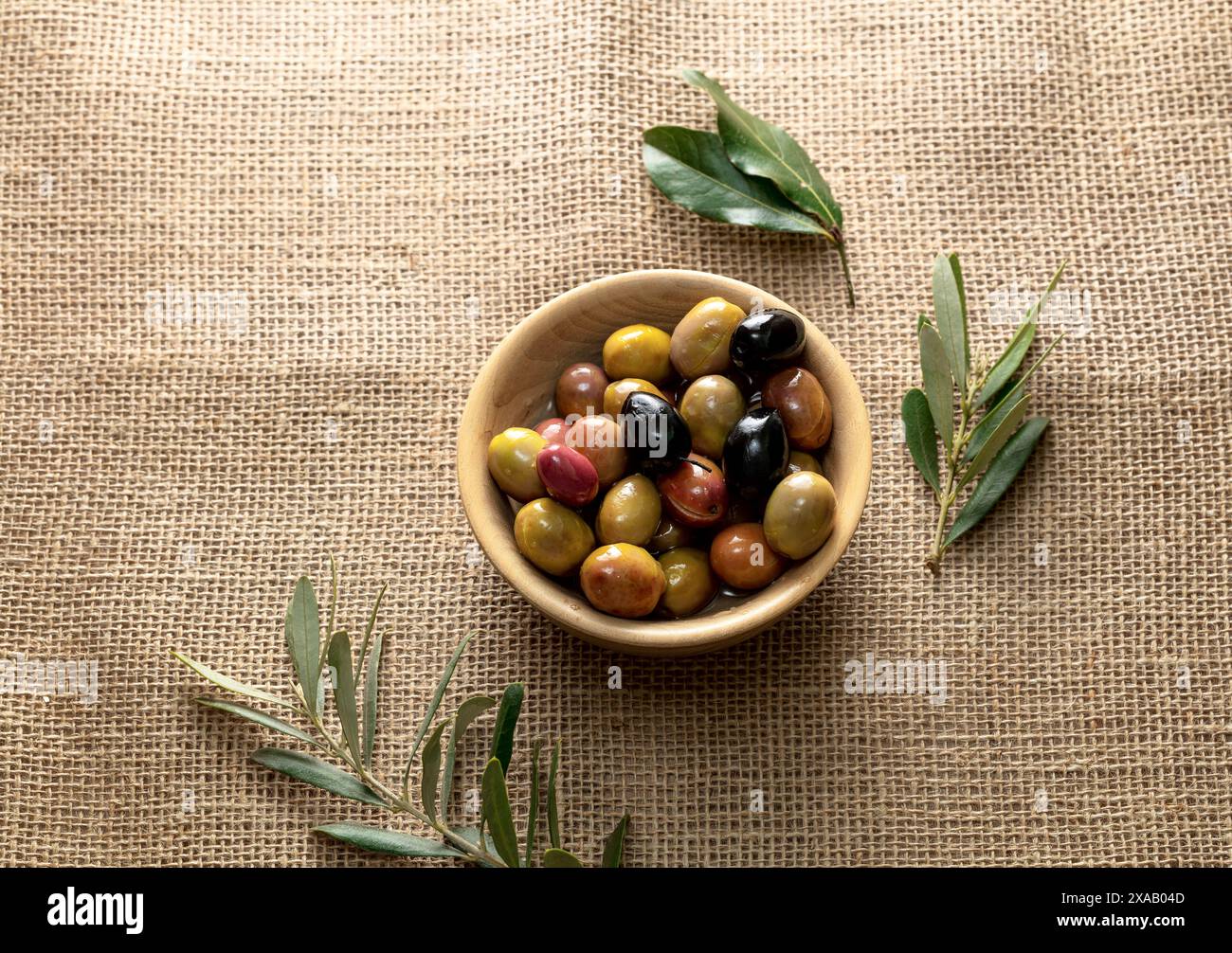 Olives in olive oil in a small bowl, with leaves, on a canvas, Istanbul ...