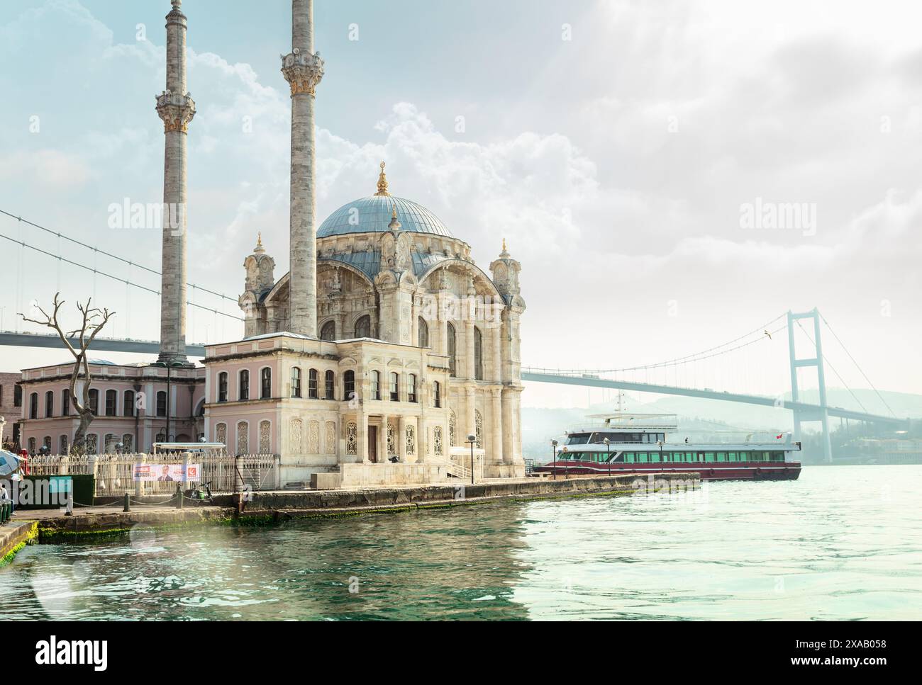 Glowing Ortakoy Mosque in the rays of the sun in cloudy weather ...
