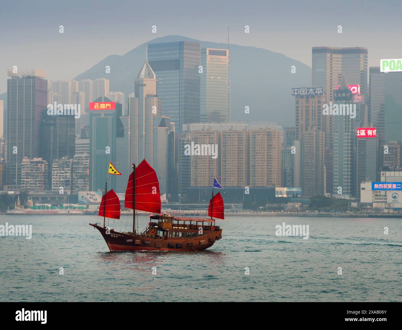 Junk with red sails, with Hong Kong Island waterfront behind, Hong Kong ...