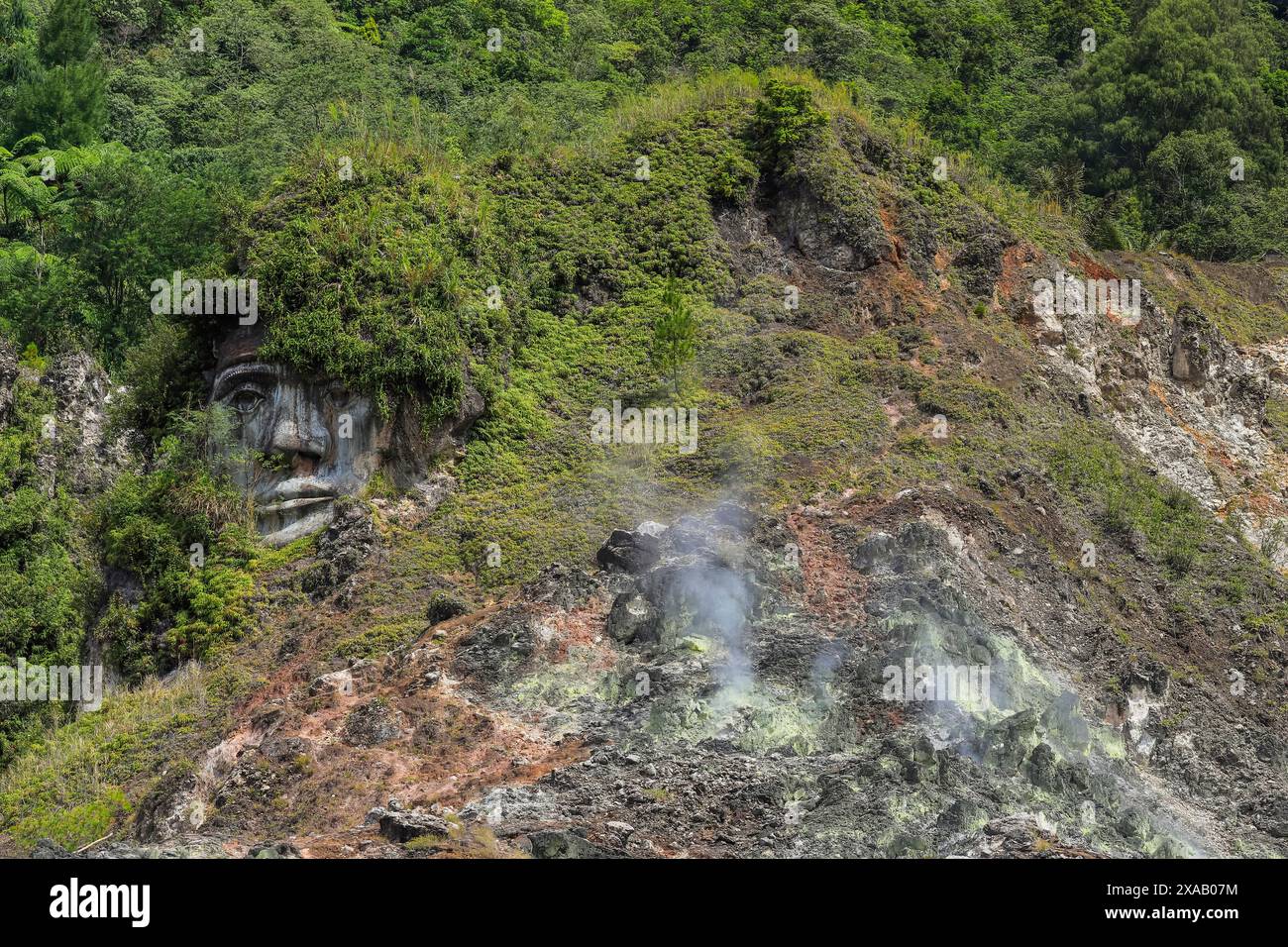 Large carved face at Bukit Kasih, a volcanic tourist park with fumarole ...