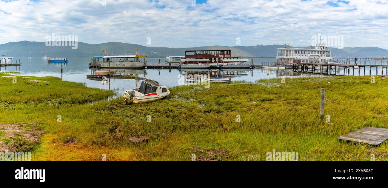 View of boats on Knysna River with Featherbed Nature Reserve in ...