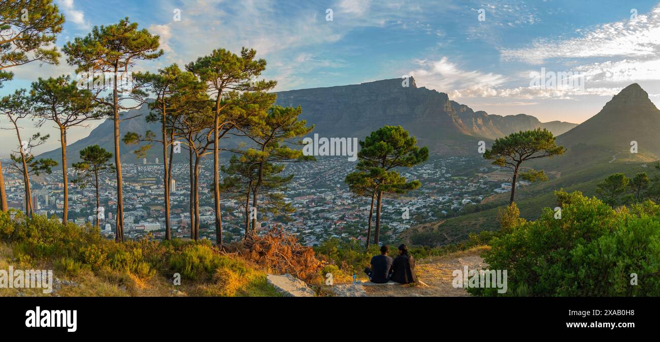 View of couple and Table Mountain from Signal Hill at sunset, Cape Town ...