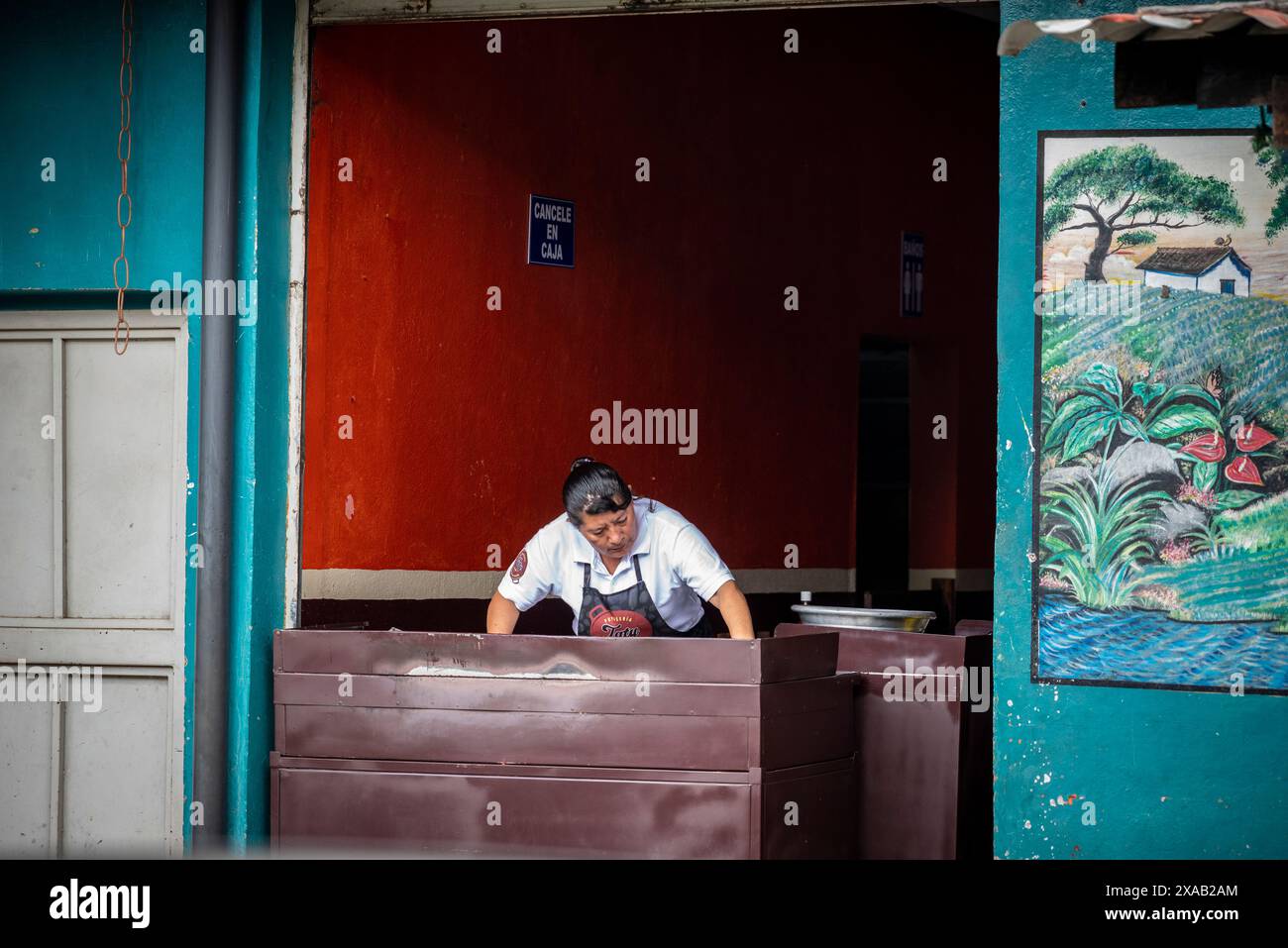 Woman making the local dish pupusa in a street pupuseria, Juayúa, town ...