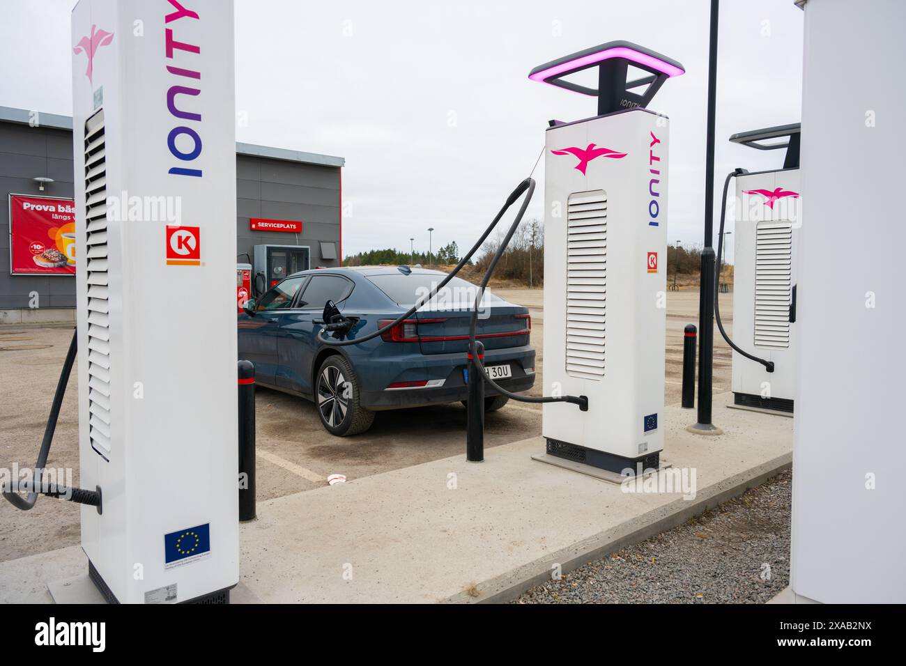 Uppsala, Sweden - March 10 2024: Blue electric car charging at an ...