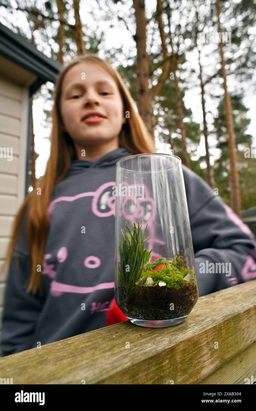 young girl with small home made natural history glass terrarium Stock ...