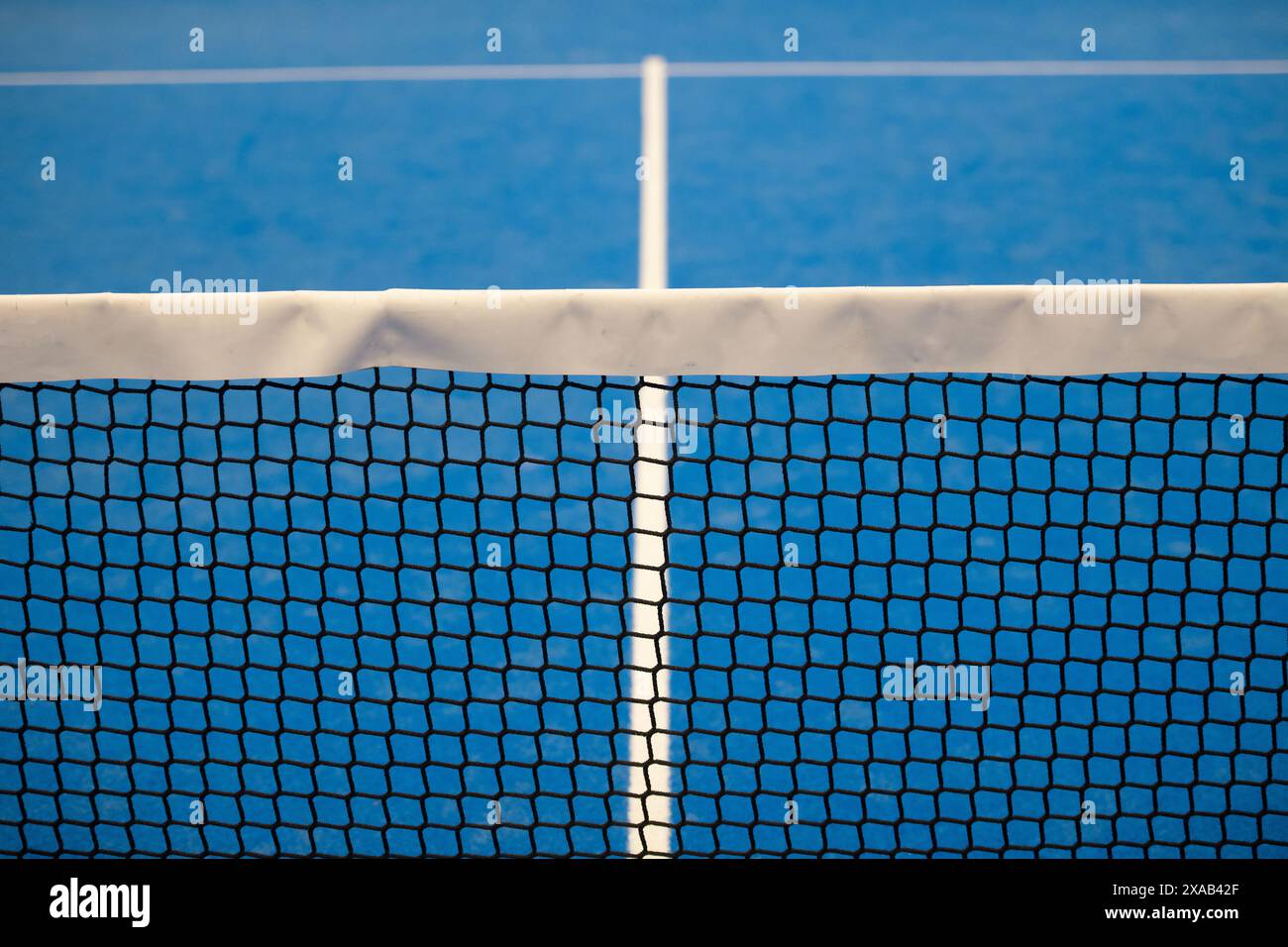 Paddle tennis and tennis net on blue court. Tennis competion concept ...
