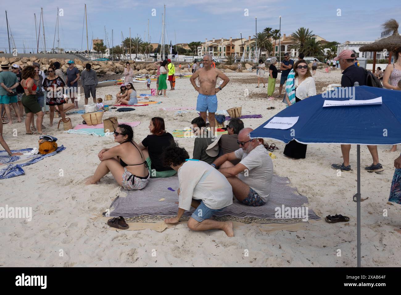 Spanish protesters at Sa Rapita beach simulating a packed beach ...