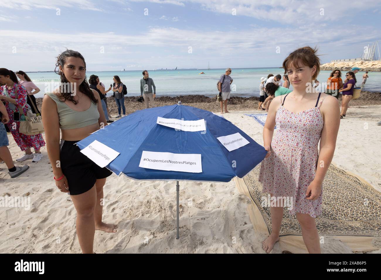 Spanish protesters at Sa Rapita beach simulating a packed beach ...