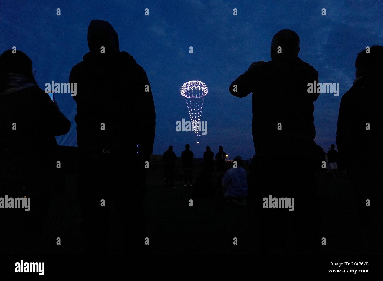 Drones make a parachute during a drone display telling the story of D ...