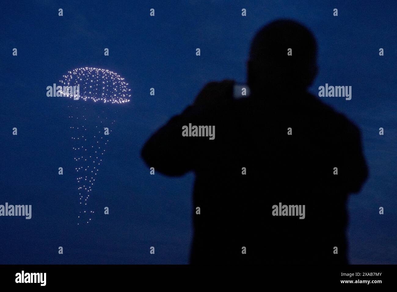 Drones make a parachute during a drone display telling the story of D ...