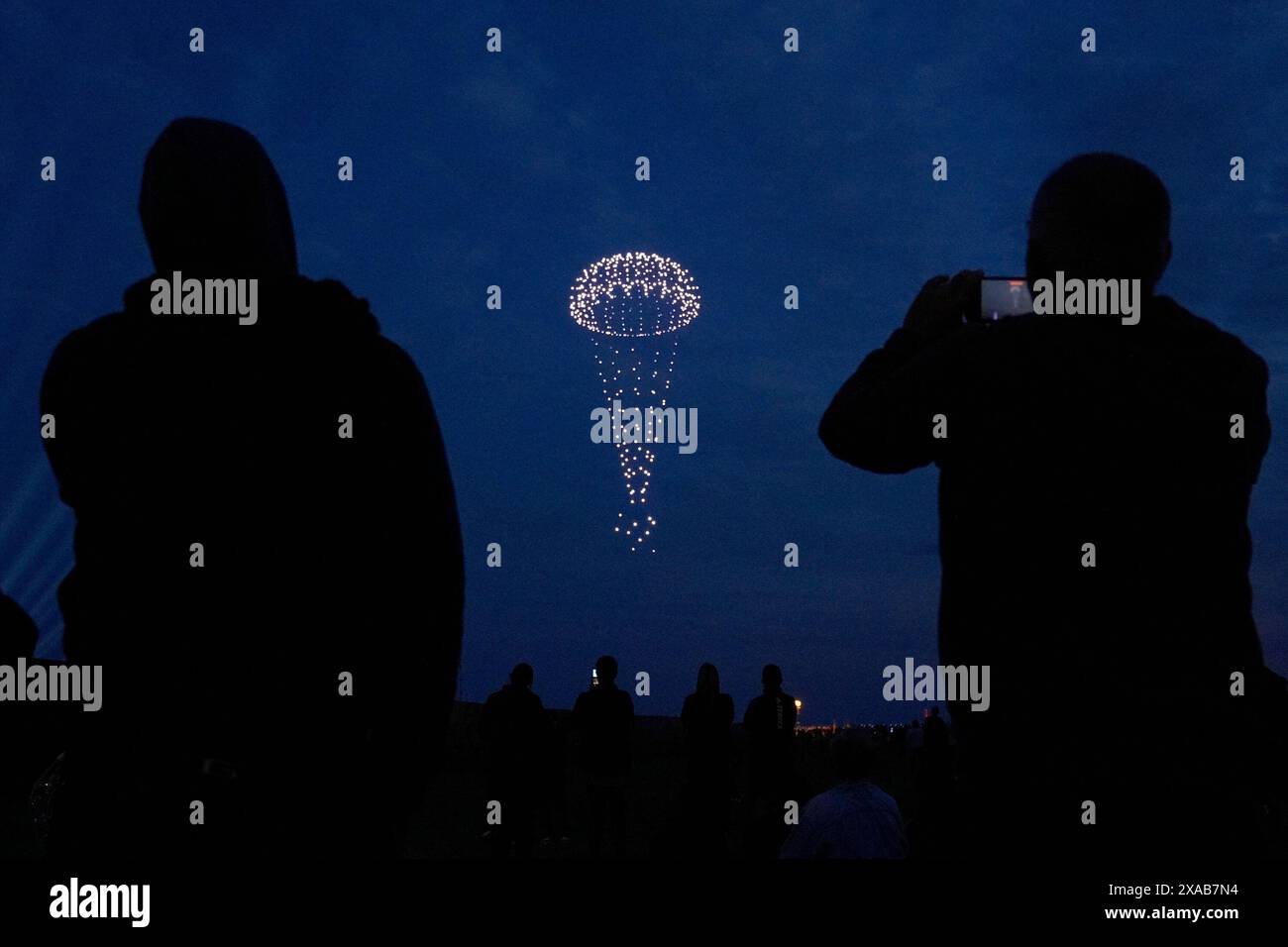 Drones make a parachute during a drone display telling the story of D ...