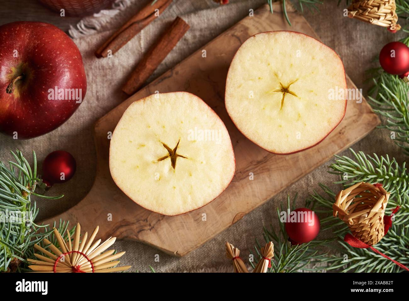 Cut apple with a star shape in the middle, with Christmas tree branches ...