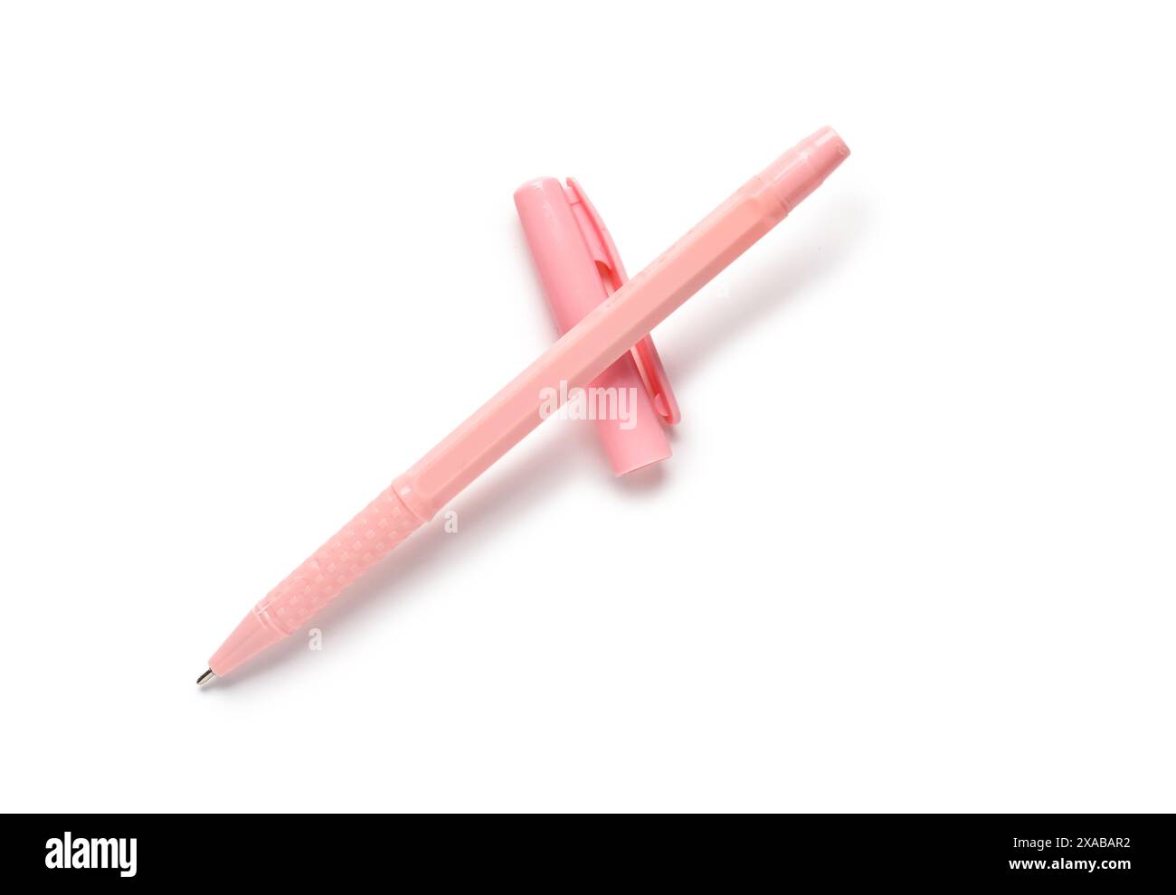 Pink ballpoint pen and cap on white background Stock Photo - Alamy