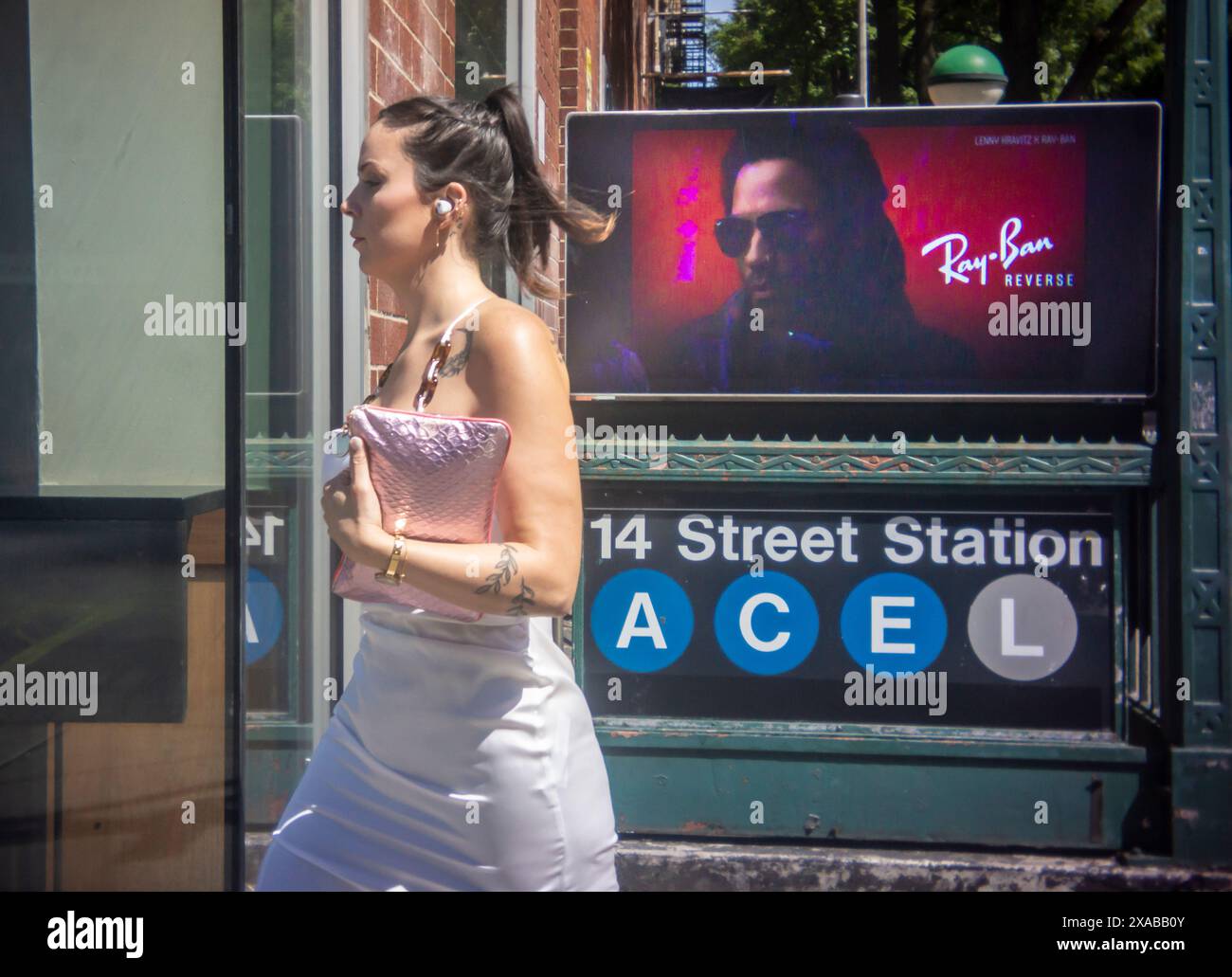 Woman walks past subway entrance with advertisement for Ray-Ban Reverse ...