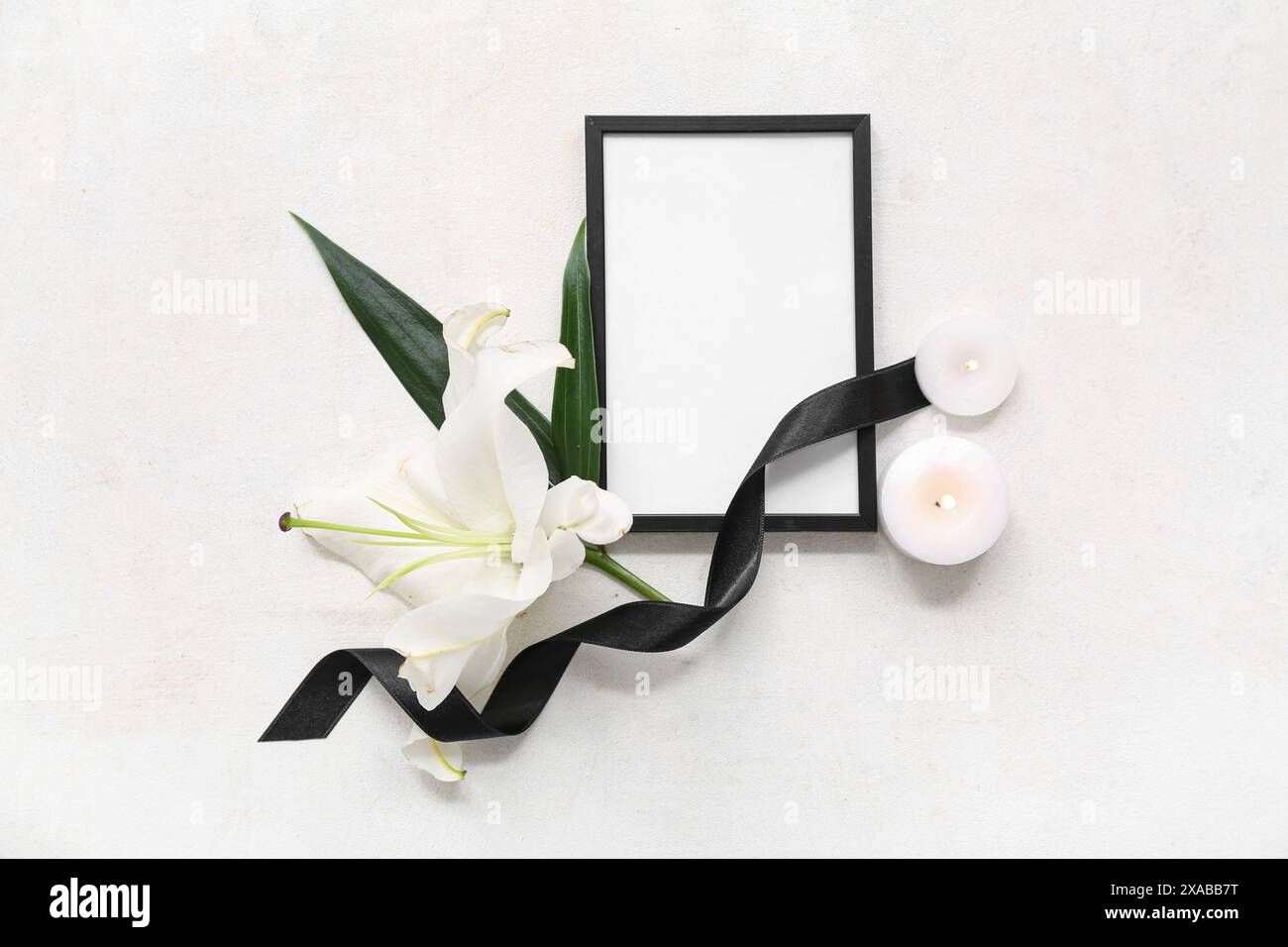 Blank funeral photo frame, candles and lily on white background Stock ...