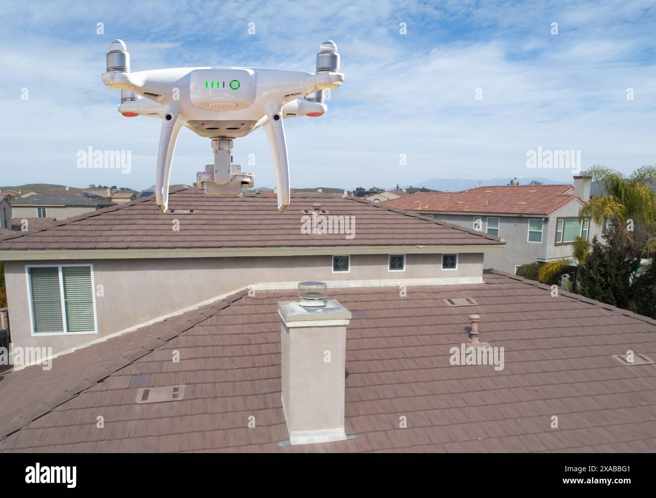 Quadcopter UAV Drone Flying A Residential Roof Inspection Stock Photo ...