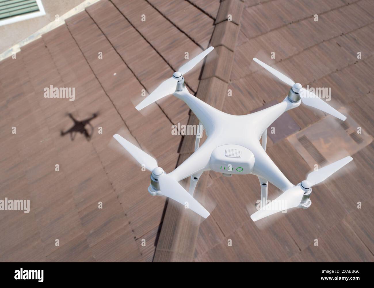 Quadcopter UAV Drone Flying A Residential Roof Inspection Stock Photo ...