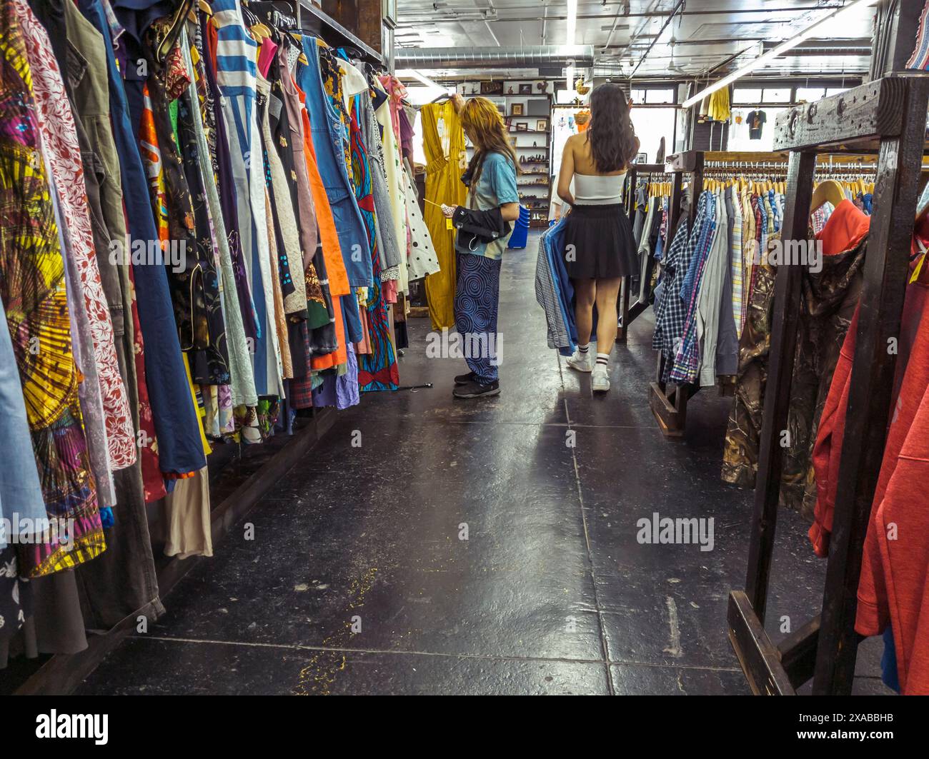 Shoppers browse second hand clothing in a store in Brooklyn in New York ...