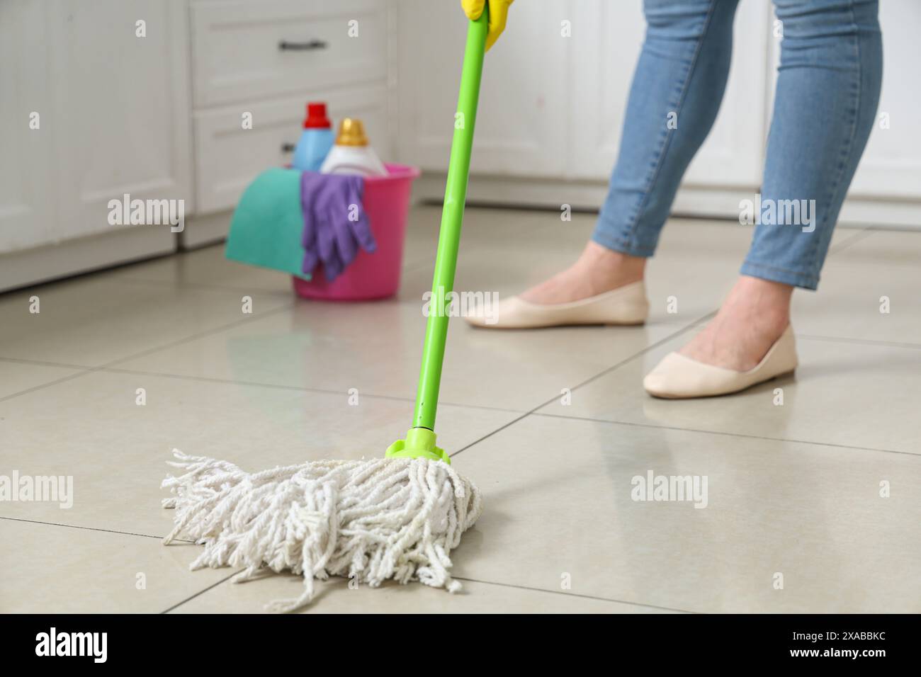 Female janitor mopping floor in kitchen, closeup Stock Photo - Alamy