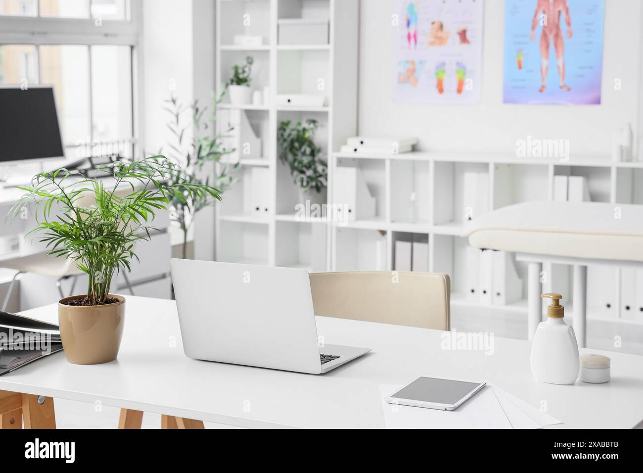 Massage therapist's workplace with laptop in medical office Stock Photo ...