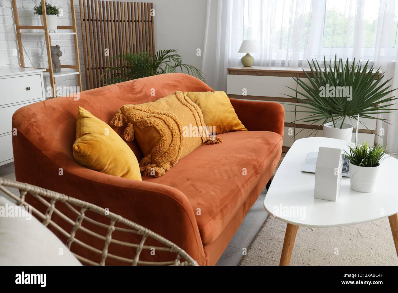 Interior of living room with red sofa, table and wooden folding screen ...