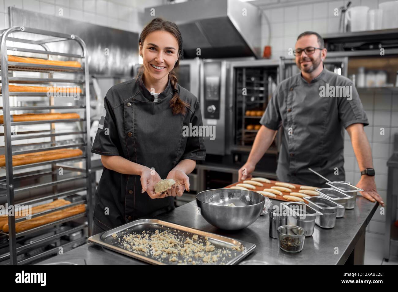 Professional bakers preparing fresh baguette in small bakery Stock ...