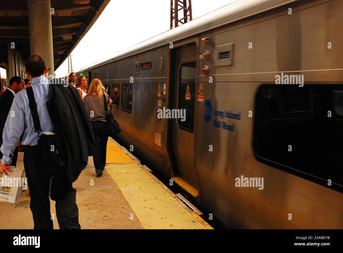 Commuters get ready to board their morning train Stock Photo - Alamy