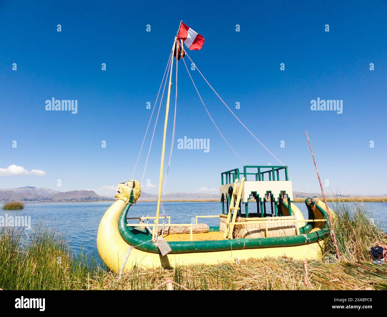 Vibrant reed boat with peruvian flag floating on the serene waters of ...