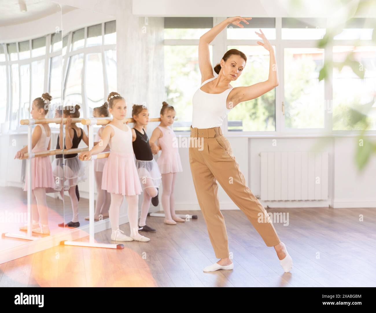Female teacher shows choreography to group of girls Stock Photo - Alamy
