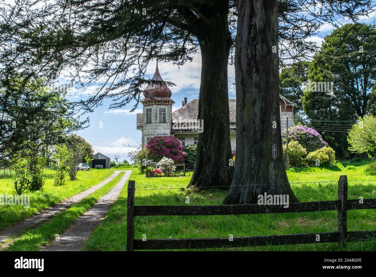 Idyllic rural scene with a vintage house and snow-capped mountain ...