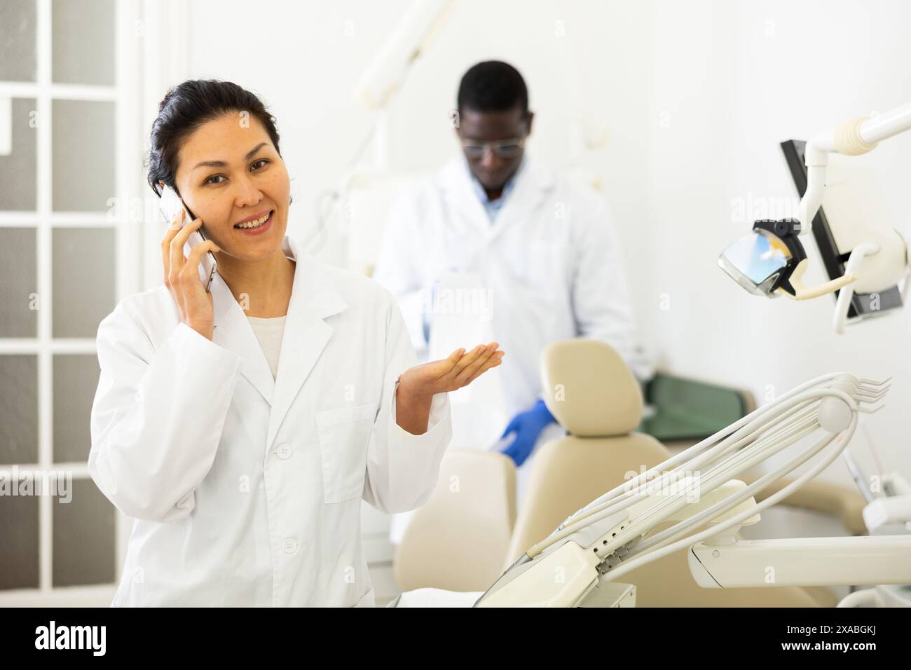 Female asian doctor talking phone hi-res stock photography and images ...