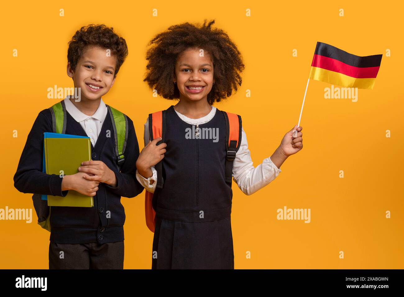 Two cheerful children backpacks hi-res stock photography and images - Alamy