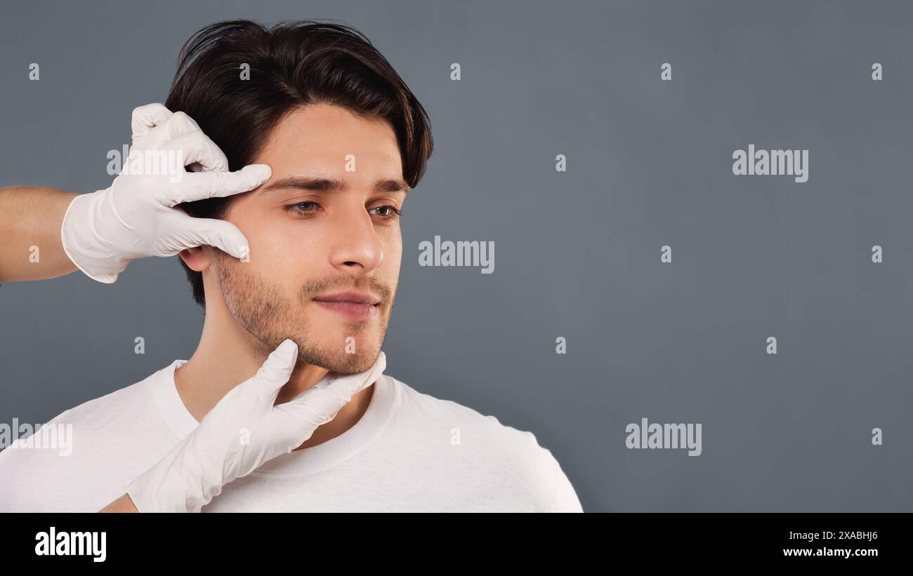 Beautician in gloves touching male patient face Stock Photo - Alamy