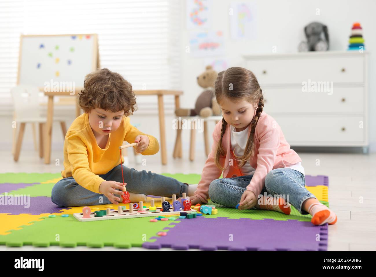 Cute little children playing with math game Fishing for Numbers on ...