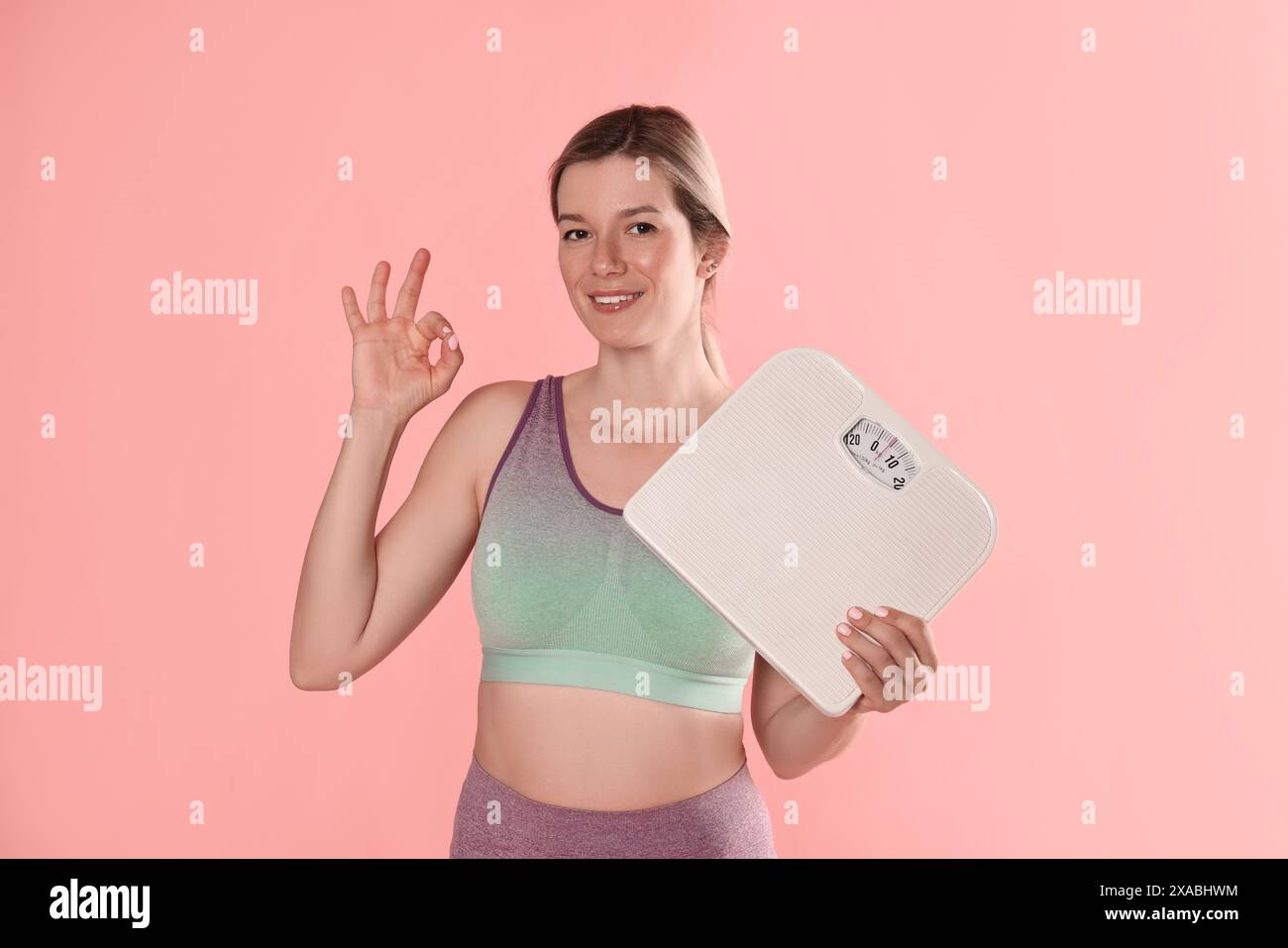 Beautiful woman with scales showing OK gesture on pink background Stock ...