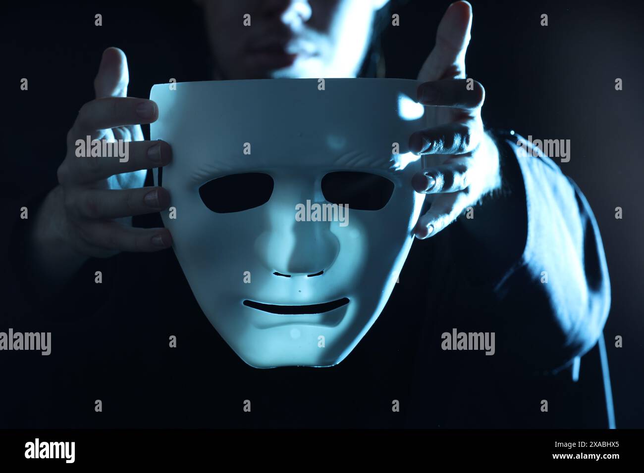 Theatrical performance. Man with plastic mask on dark background ...