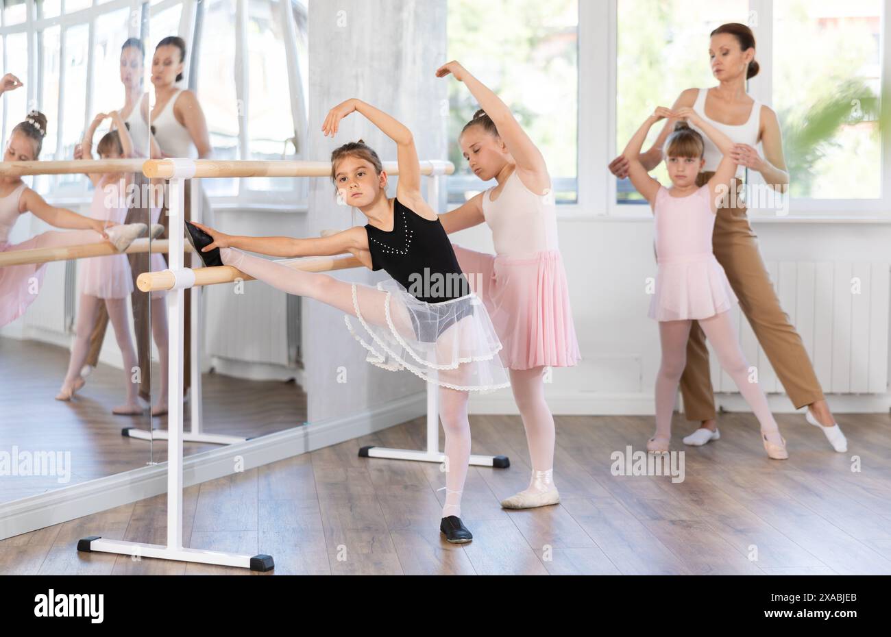Ballet pose grand batman - little girls at a choreography lesson are ...