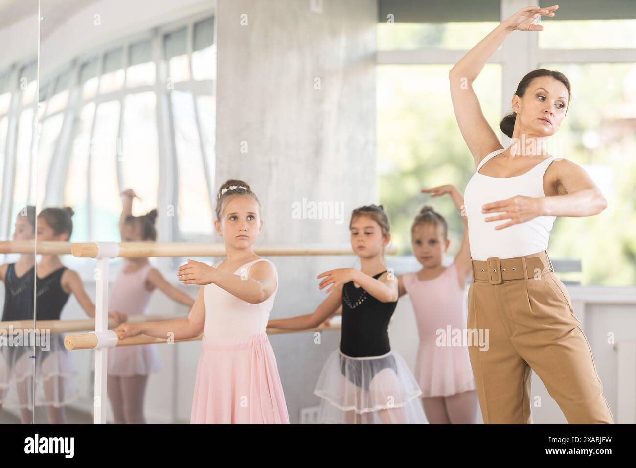 Female teacher shows choreography to group of girls Stock Photo - Alamy