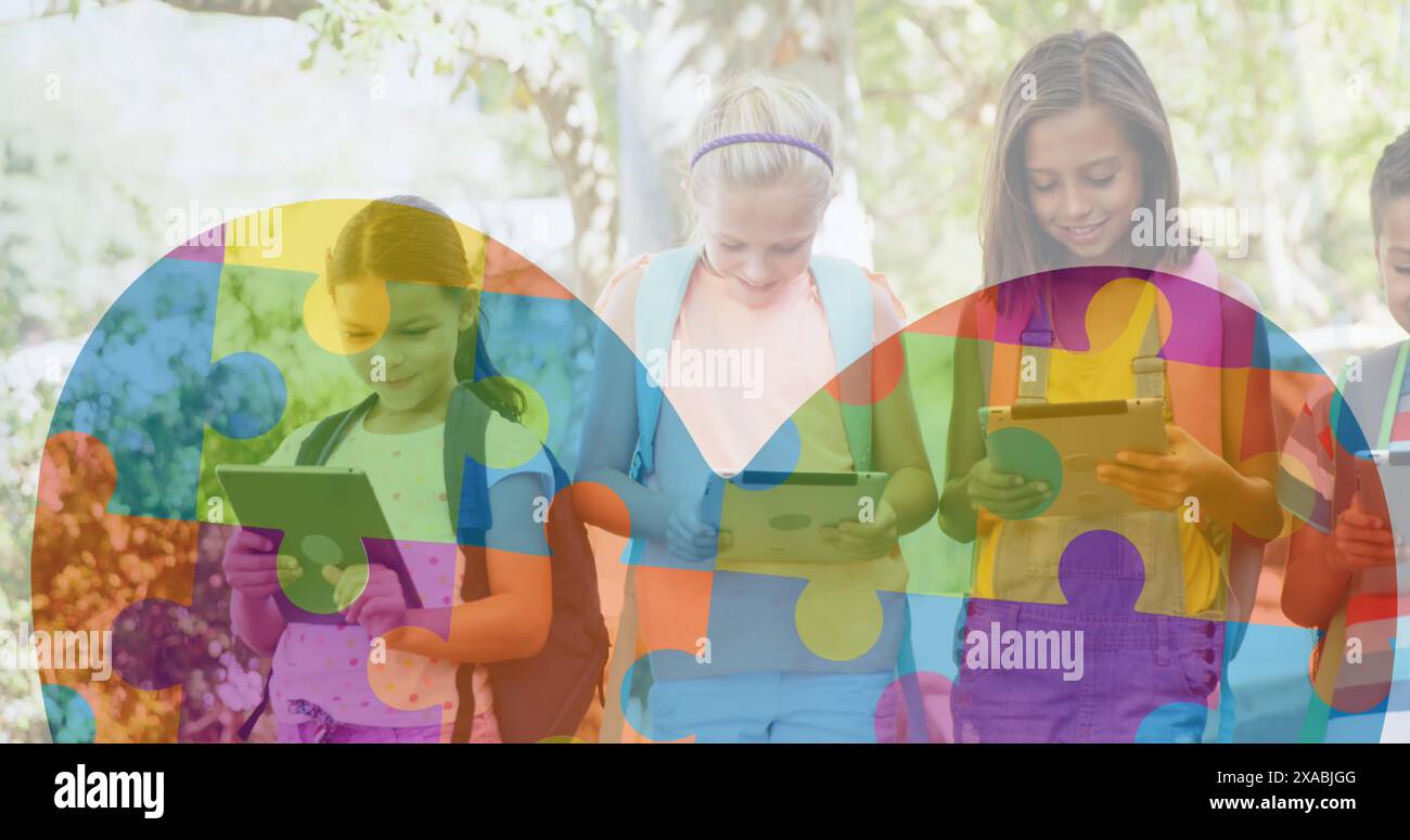 Image of colourful puzzle pieces and heart over kids friends using ...