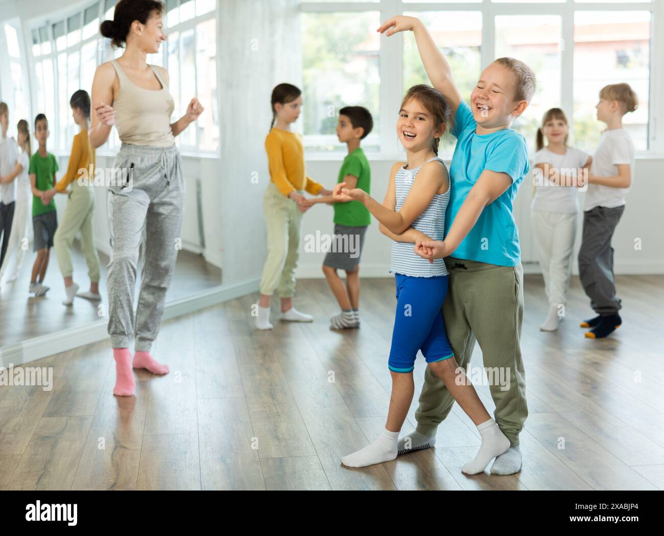 Preteen children learning to dance waltz in pairs in choreography class ...