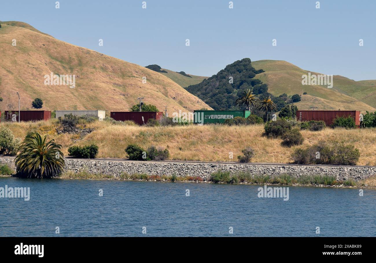 freight train container cars next to the Alameda Creek in California ...