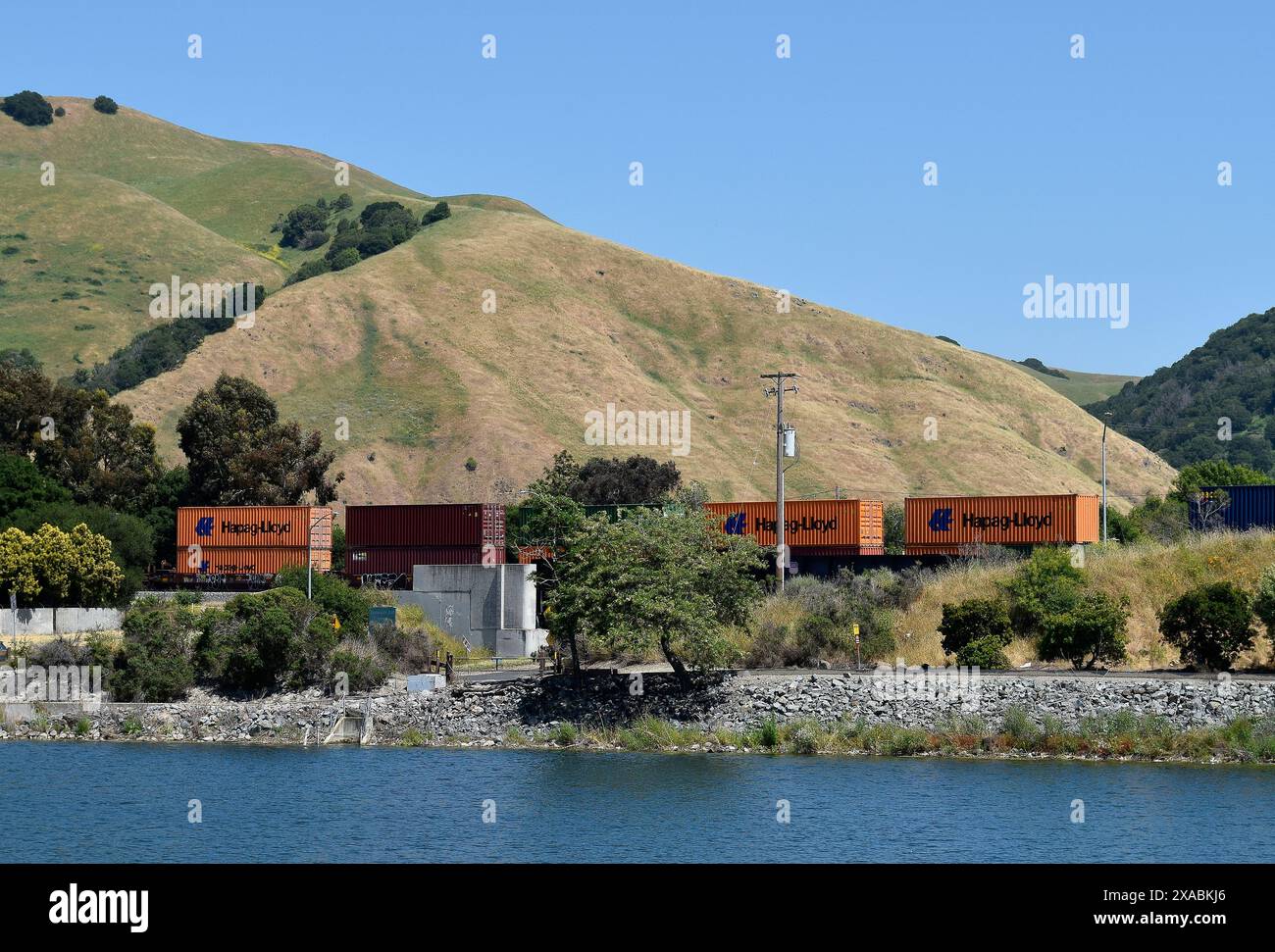 freight train pulling Hapag-Lloyd container cars next to the Alameda ...