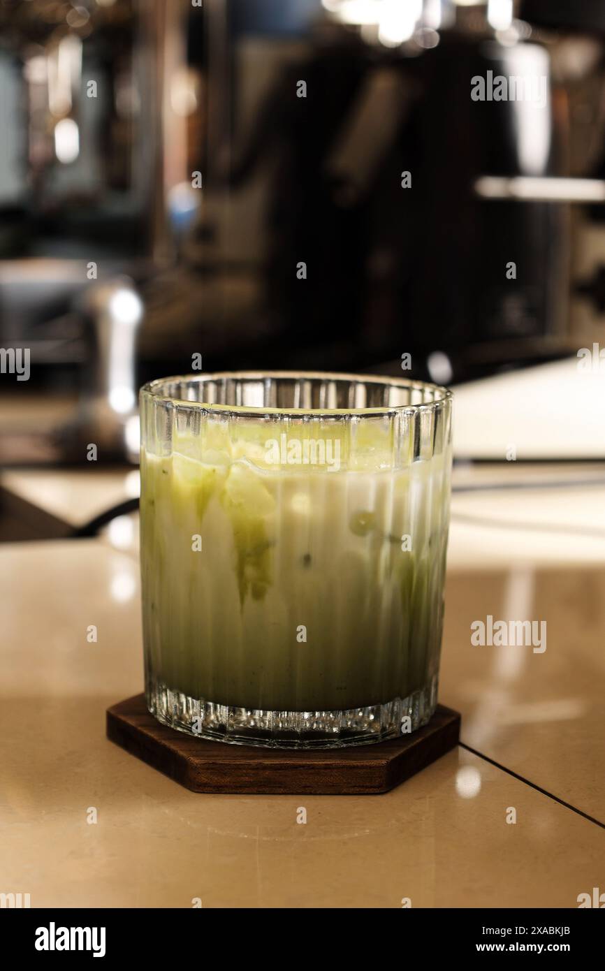 Matcha Green Tea Latte Serve with Small Glass on Table Bar Barista with ...