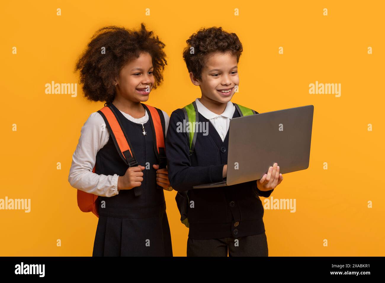 Two Children Wearing School Uniforms Using Laptop Stock Photo - Alamy