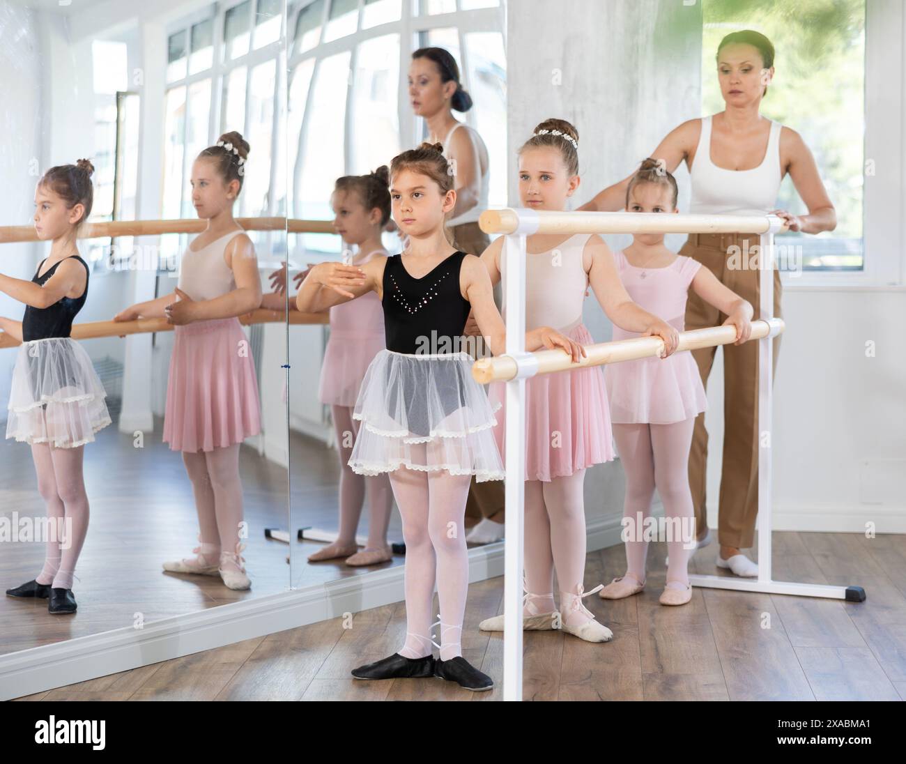 Ballet choreographer teaches little children to get into first position ...