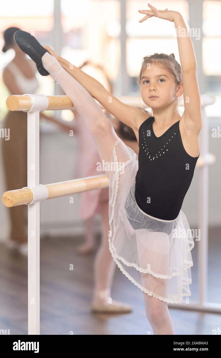 Ballet pose grand batman - little girls at a choreography lesson are ...
