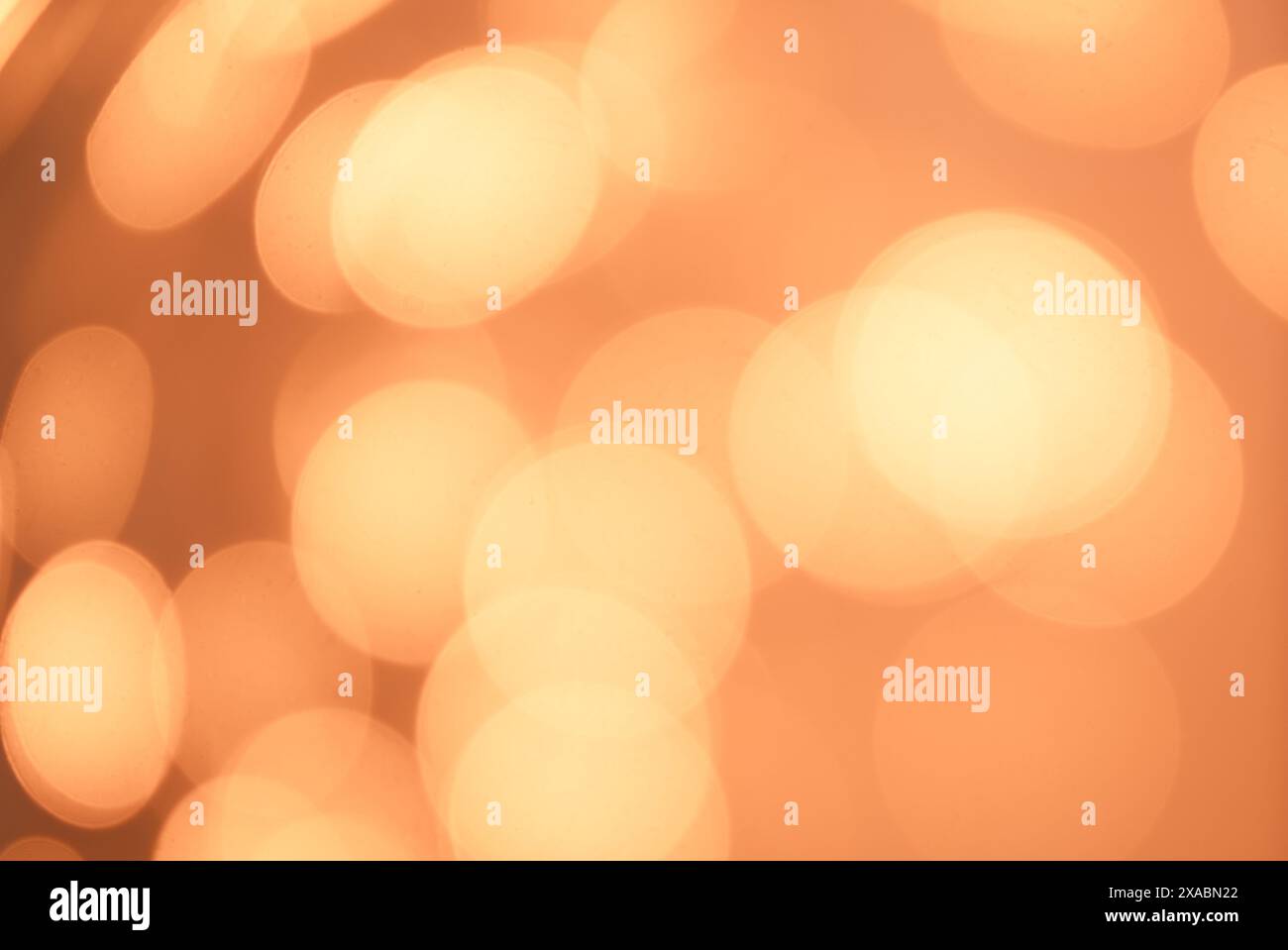 Blurred pastel orange-peach background. Geometric bokeh patterns ...