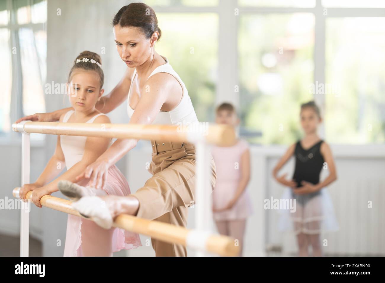 Ballet pose grand batman - little girls at a choreography lesson are ...