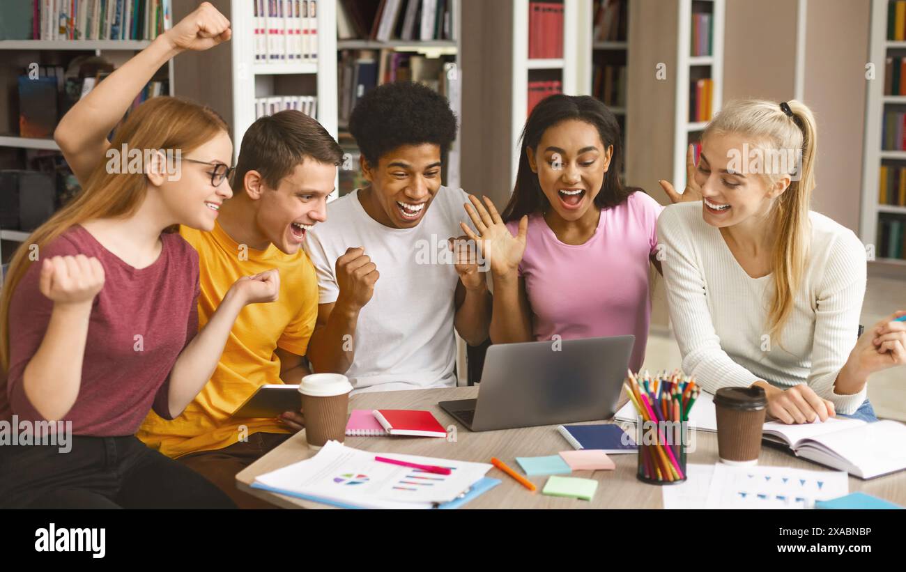 Group of young happy students enjoying test results in library Stock ...