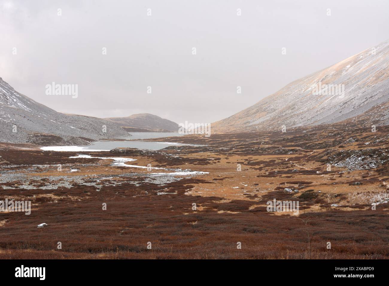 A chain of lakes flowing down from the glacier through a narrow valley ...